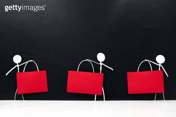 Stick man figure holding blank red signage template in dark background ...