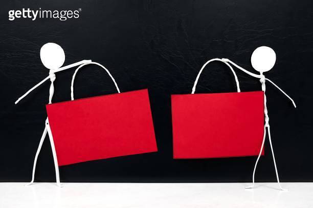 Stick man figure holding blank red signage template in dark background ...