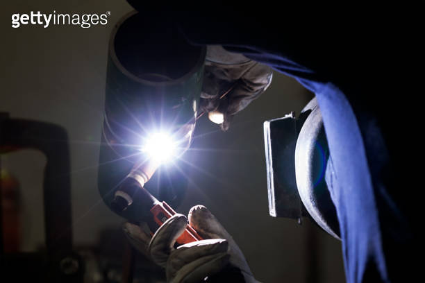 The welder is welding to pipe for welder qualification with gas ...