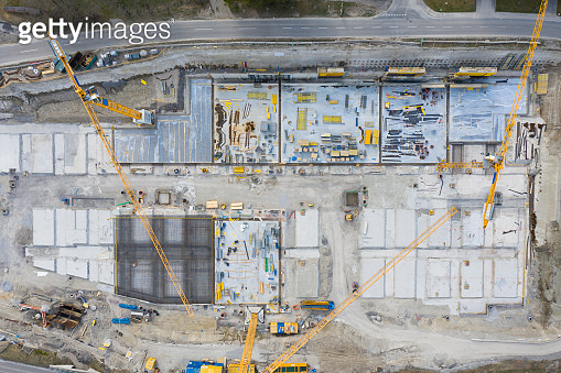 aerial bird eye top view to huge construction site with cranes diggers ...