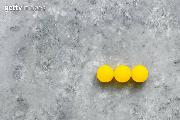 Color of the year 2021 yellow and gray. Yellow plastic balls in a row ...