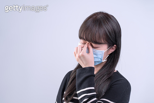 Young woman is feeling dizzy, headache, sick, unwell with wearing a ...