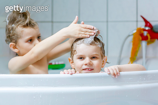 Happy siblings: Two little healthy twins children playing together with ...