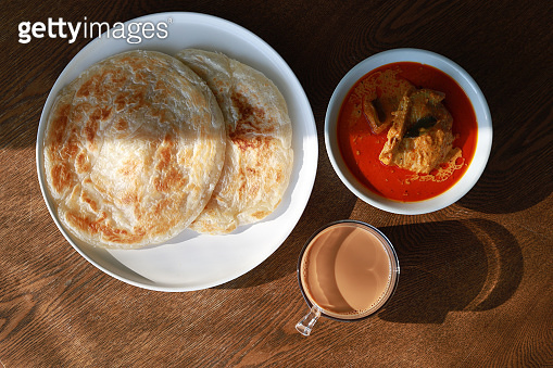 Roti Paratha or Roti Canai with chicken curry sauce and a cup of milk ...