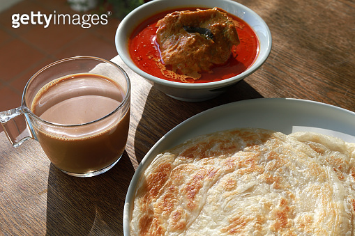 Roti Paratha or Roti Canai with chicken curry sauce and a cup of milk ...
