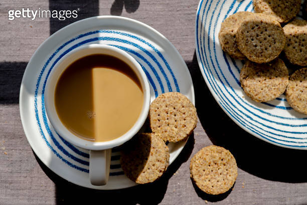 coffee break: coffee and home baked whole wheat biscuits in sunlight ...