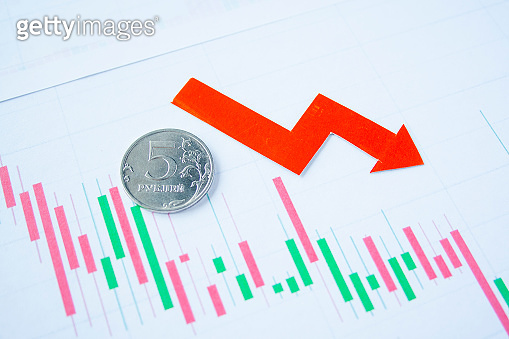 five rouble coin on currency graph with red arrow down. exchange rate ...