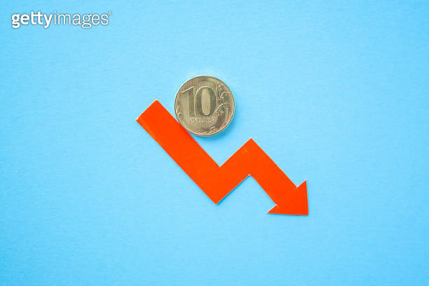 ten rouble coin on blue background with red arrow down. exchange rate ...