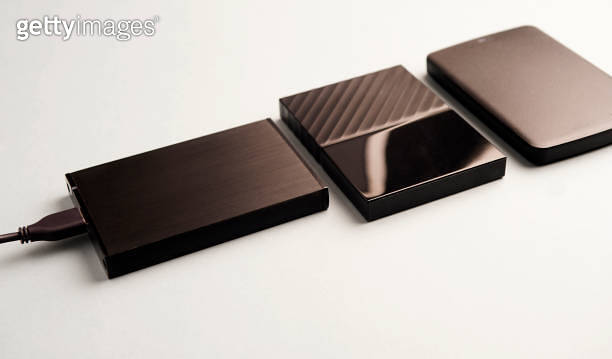 front three hard drives different sizes, one black with usb cable ...