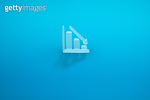 a falling graph in a blue background. a falling arrow. 3D rendering ...