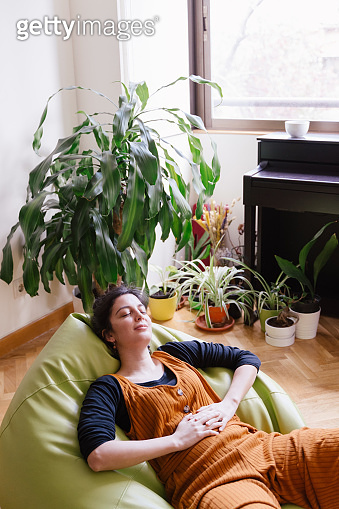 Vertical side view of woman relax and laying down during quarantine ...