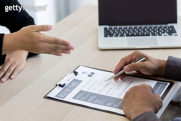 The manager is about to shake hands with the job applicant after the ...