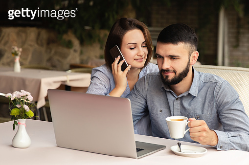 Young couple in love working from home, man and woman sitting at the ...