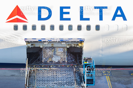 Loading of a cargo container on board of a Delta Airlines airplane on ...