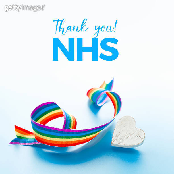 Rainbow ribbon and hand holding heart. "Thank you NHS" on blue ...