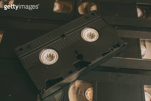 Stack of VHS video tapes as background. Old video cassette tapes. Retro ...