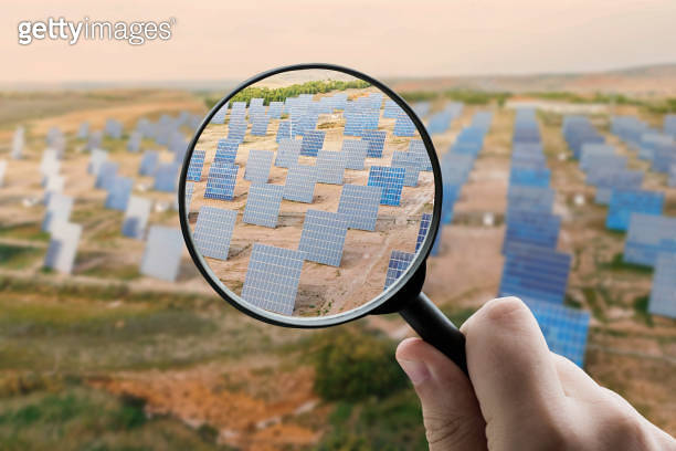 Magnifying glass focusing on solar panels - Renewable energy 이미지 ...