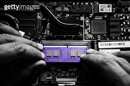 Close-up on the purple RAM memory that the hands of the service ...