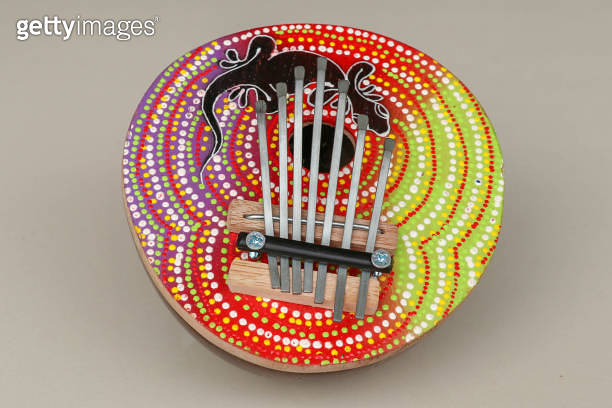 Traditional musical instrument karimba with gecko lizard motif. Close ...
