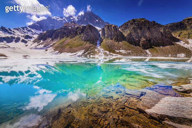 Melting frozen Lake Agnel between Alpine landscape – Gran Paradiso ...