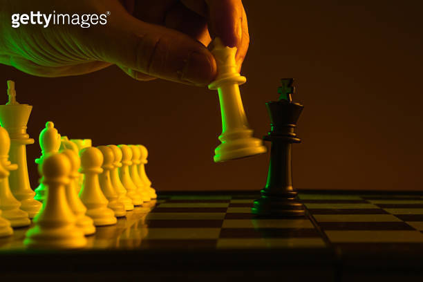 Close-up hand makes a move, check and checkmate, chess, chessboard ...