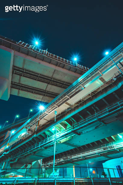 Tokyo Bay Rainbow Bridge highway harbour loops illuminated dusk Japan ...