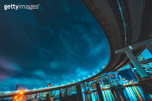 Tokyo Bay Rainbow Bridge highway harbour loops illuminated dusk Japan ...