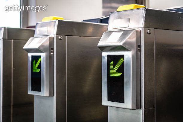 Turnstiles with electronic card readers on the subway station platform ...