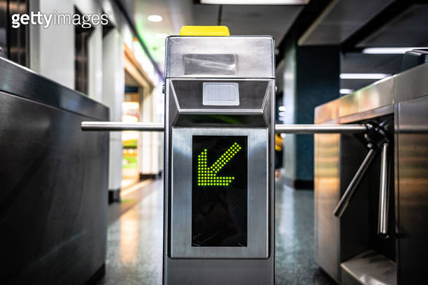 Turnstiles with electronic card readers on the subway station platform ...