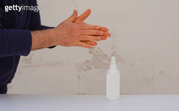 Disinfecting hands using antiseptic spray on hands to prevent ...