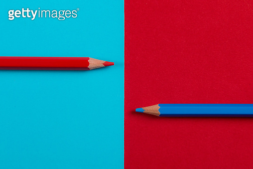 Two colored pencils split a picture in half in two different colors,red ...