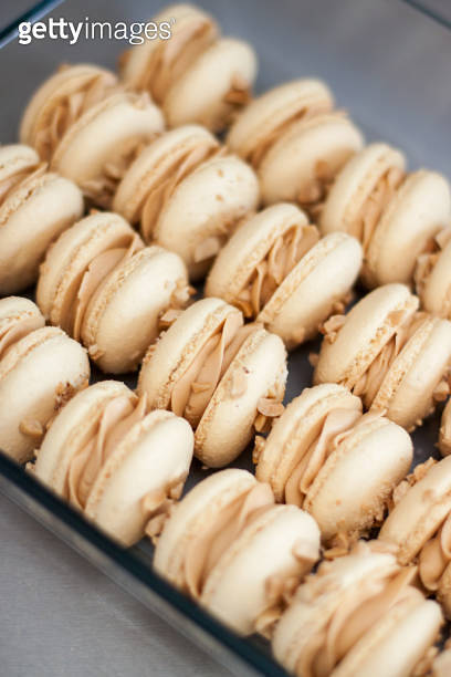 Homemade french macaroons with brown shells, peanut butter cream and ...