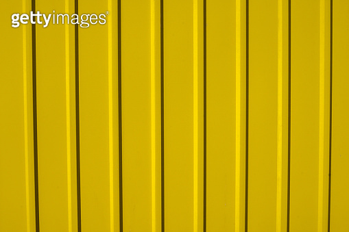 Yellow metal sheet panel or cladding with vertical line wave pattern ...