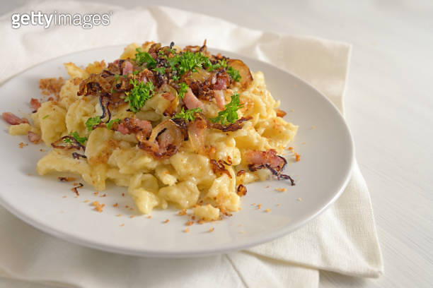 Homemade German egg pasta, called spaetzle, with cheese, roasted bacon ...
