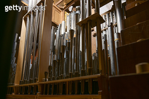 Inside a church organ, register with different pipes from metal ...