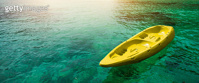 Yellow Canoe floating on the calm water under amazing sunset.Summer ...