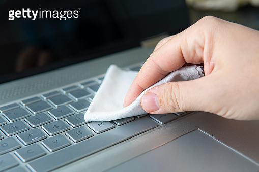 cleaning man with rag of a computer keyboard. disinfecting measures to ...