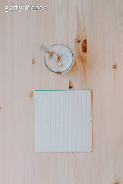 Work time concept. Coffee and a notebook on a natural pine table. Quiet ...