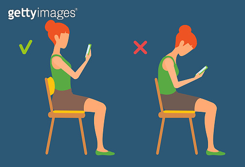A girl sits on a chair bent and straightened, reading the smartphone ...