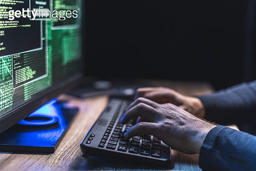 Typing on a keyboard with data on a monitor (1212752382) - 게티이미지뱅크