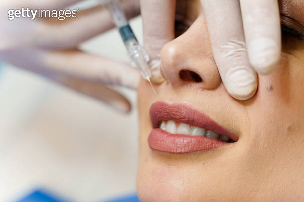 Closeup lips augmentation injections for attractive girl. Plastic ...