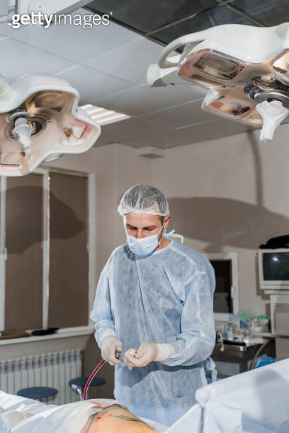 Surgeon removes fat in the gluteal region. Abdominoplasty - plastic ...