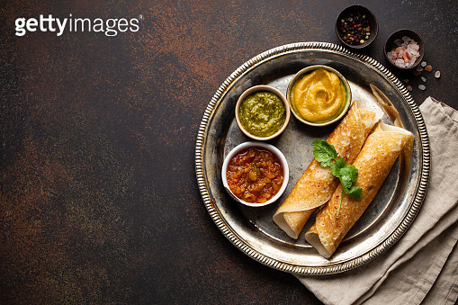 Traditional Indian rice pancakes Dosa with different dips chutney, on ...
