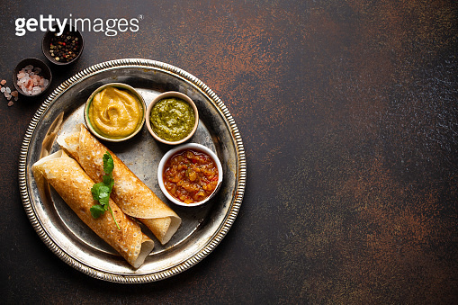 Traditional Indian rice pancakes Dosa with different dips chutney, on ...