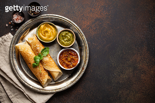 Traditional Indian rice pancakes Dosa with different dips chutney, on ...