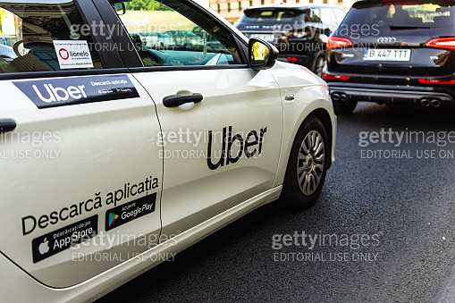 Uber car in traffic, modern city taxi service. Car pollution, traffic ...