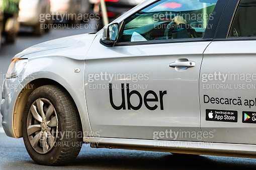 Uber car in traffic, modern city taxi service. Car pollution, traffic ...
