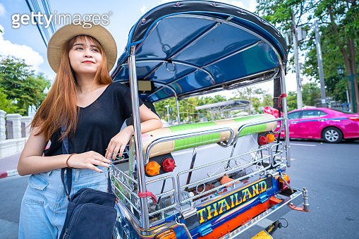 Cute Asian tourists are traveling to Bangkok in Thailand. Take a tuk ...