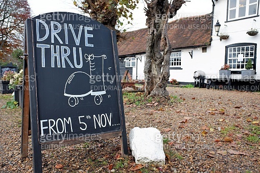 Sign outside pub advertising drive through meals during the UK's second ...
