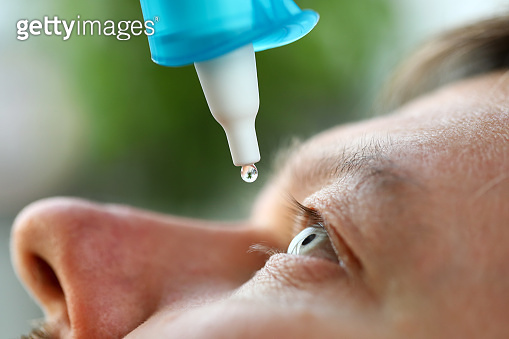 Man putting liquid drops in his eye solving vision problem 이미지 ...